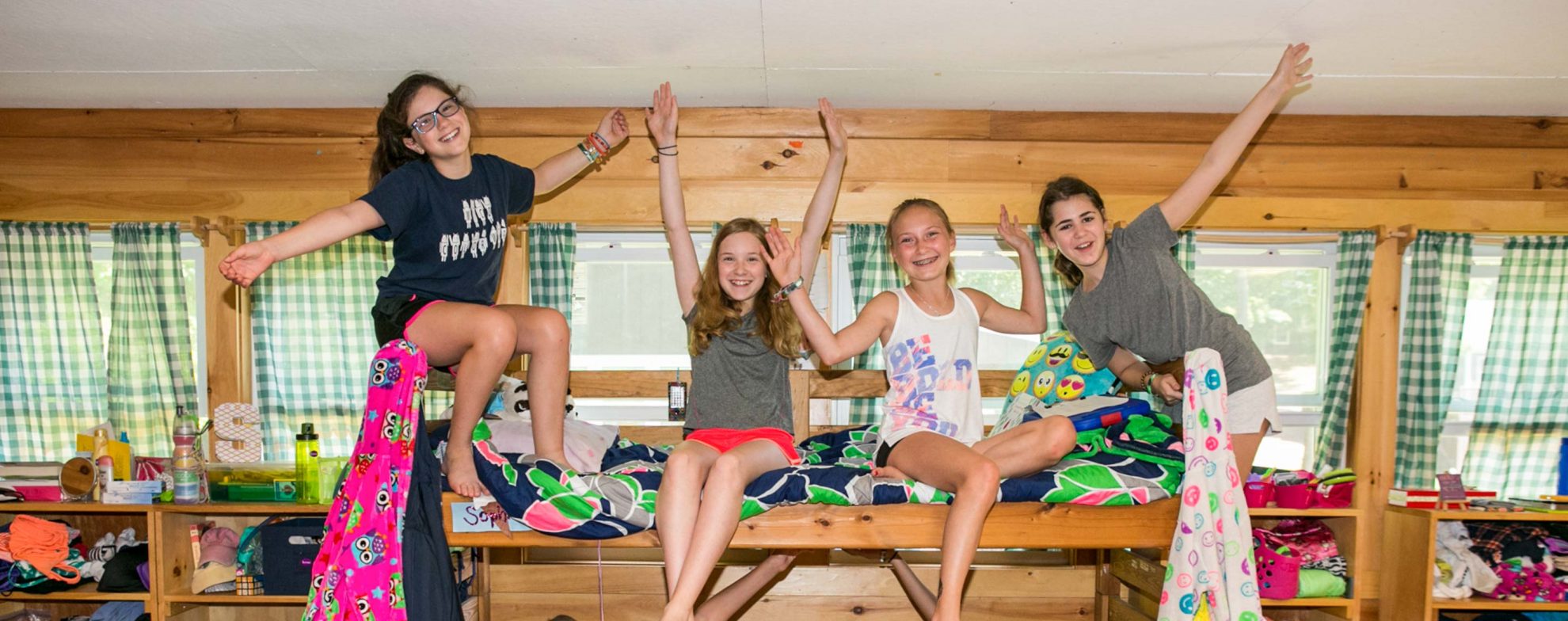 happy-girls-in-bunk - Camp Wicosuta
